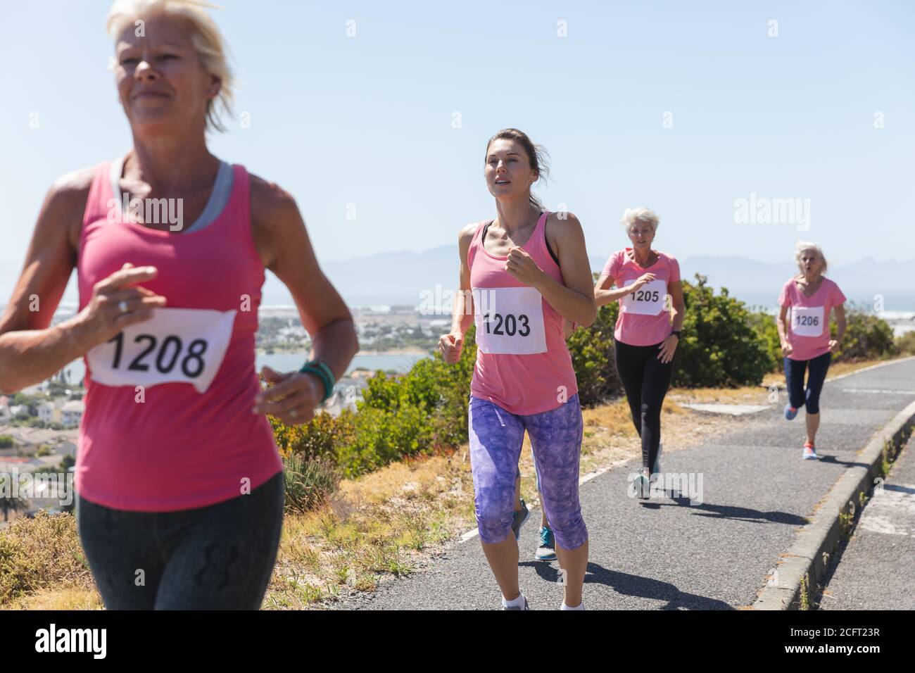 Group of woman running Stock Photo - Alamy