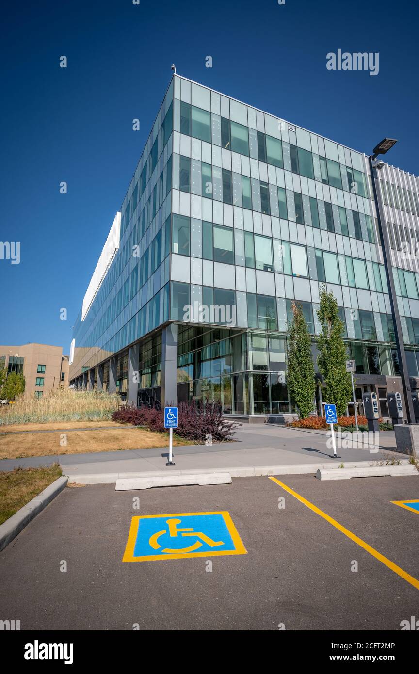 Wheel chair sign freshly painted in parking spot of modern building ...