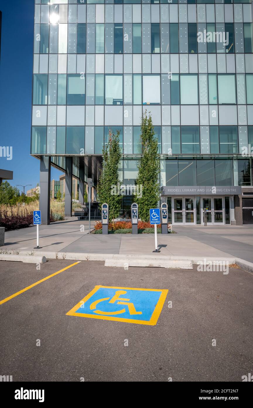 Wheel chair sign freshly painted in parking spot of modern building ...