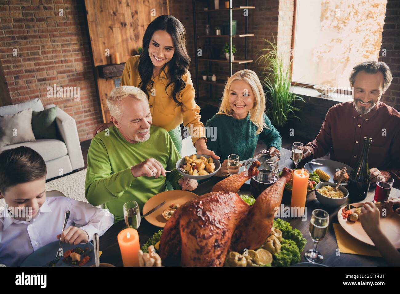 Portrait of nice attractive adorable cheerful family eating mom serving ...