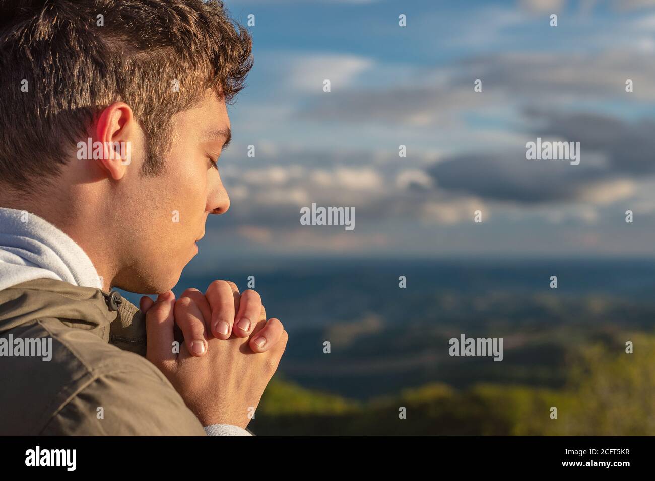 Young man praying in church hi-res stock photography and images - Alamy