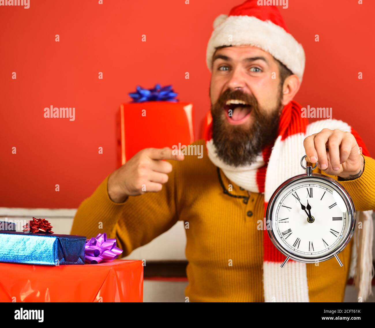 Santa Claus portrait pointing at clock showing five minutes to midnight ...