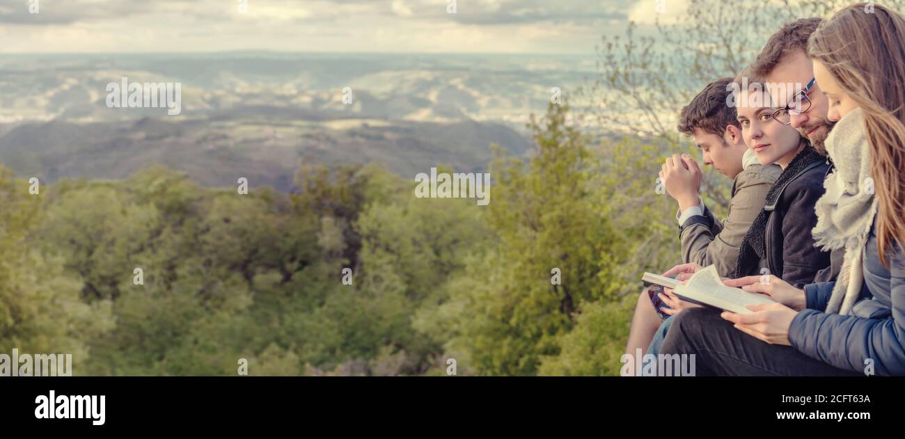 Christian worship and praise. Friends praying and reading the bible in ...