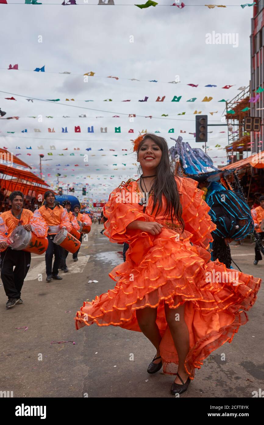 Female dancers in colourful costumes parade through the mining city of ...