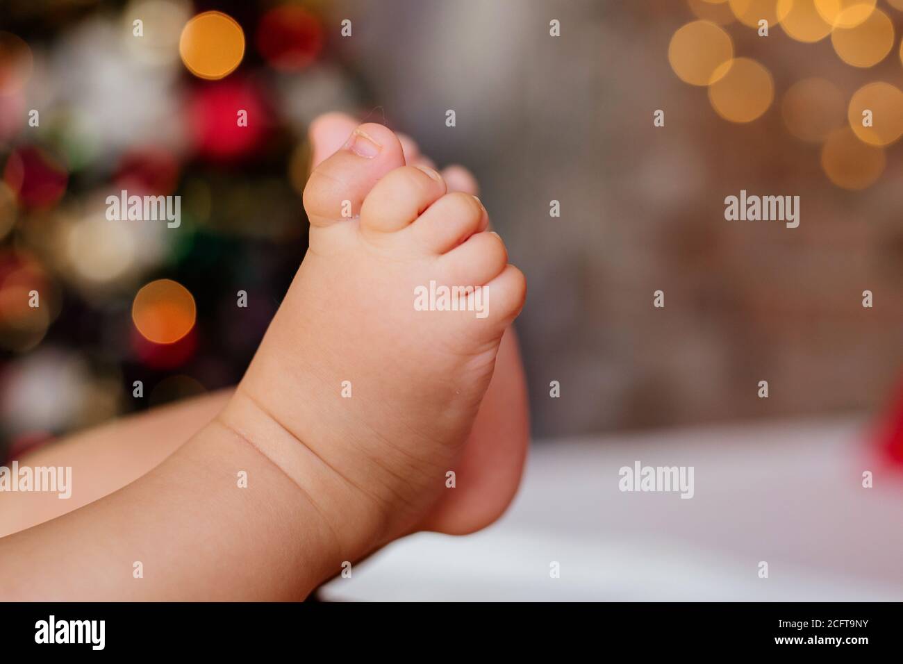 Newborn baby's legs in the background of the back of the light Stock ...