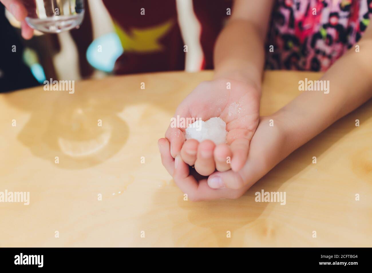 Hand holding white polystyrene foam beads ball drop from Styrofoam ...