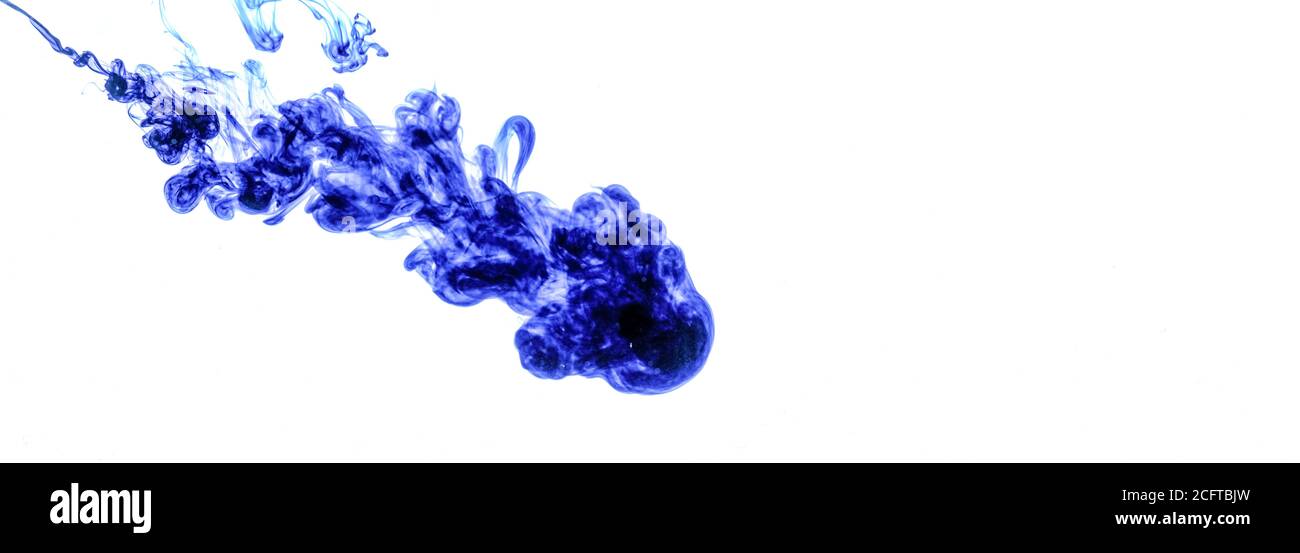 Blue ink injected into water from syringe, colour mixing with water ...