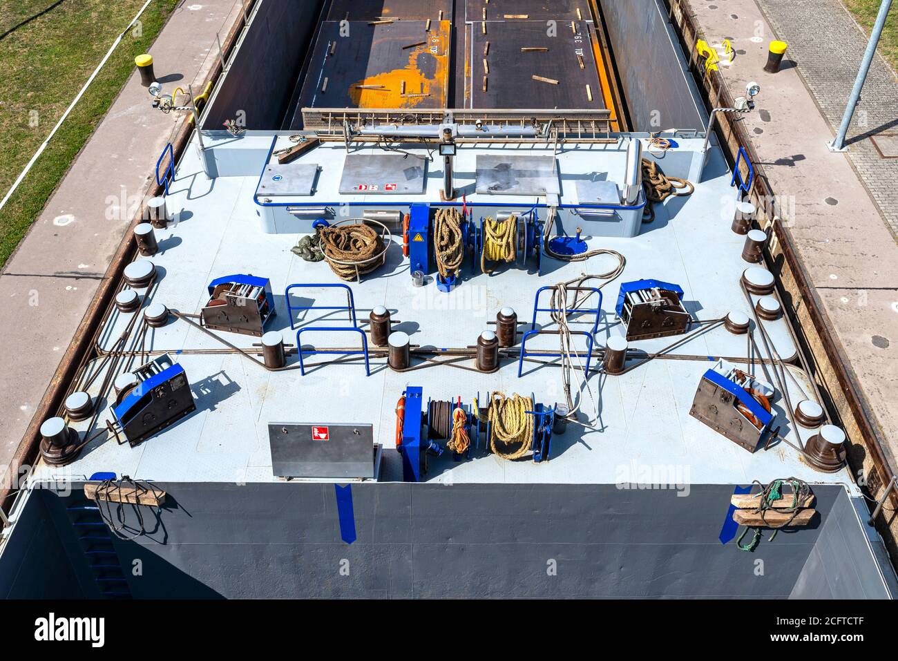 Barge filled with sheets of thick metal, flowing into the river lock ...