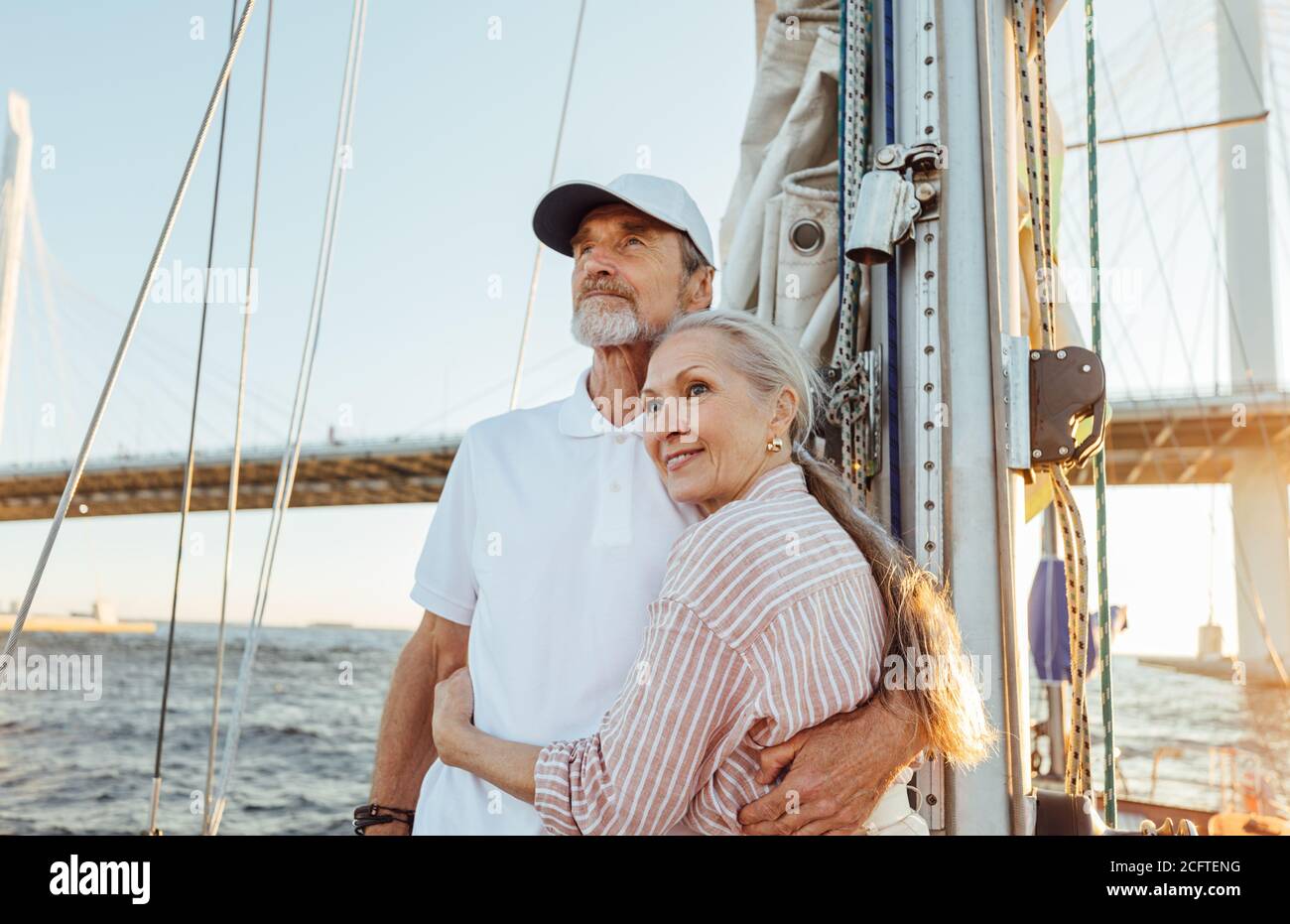 Affectionate senior couple hugging together and looking into the ...