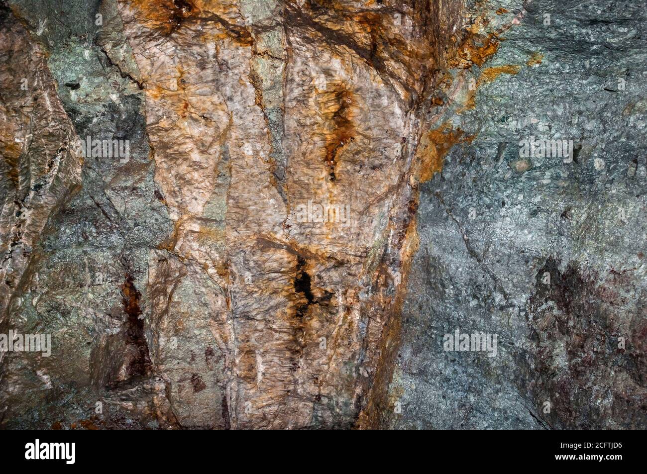 Exposure of light-blue volcanic ash (tuff) near a mineral vein in an ...