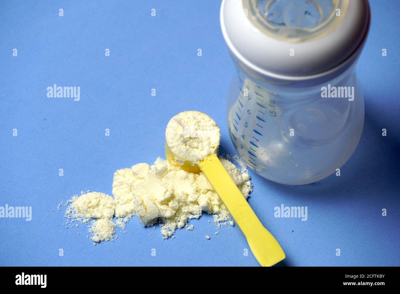 top view of baby powder milk with scoop next to a baby bottle. formula ...