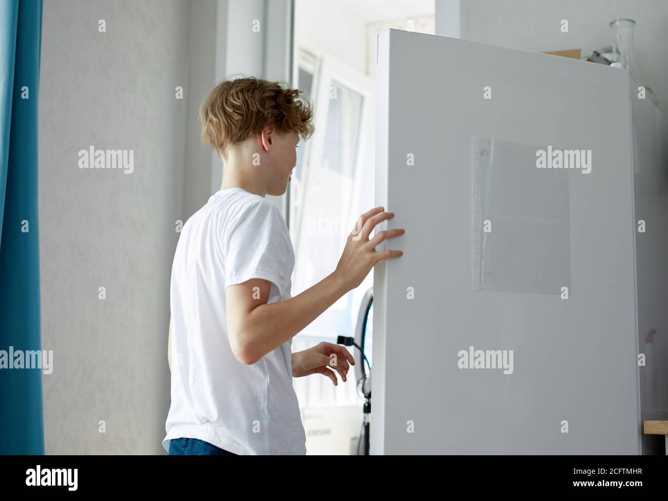 Boy looking in refrigerator hi-res stock photography and images - Alamy