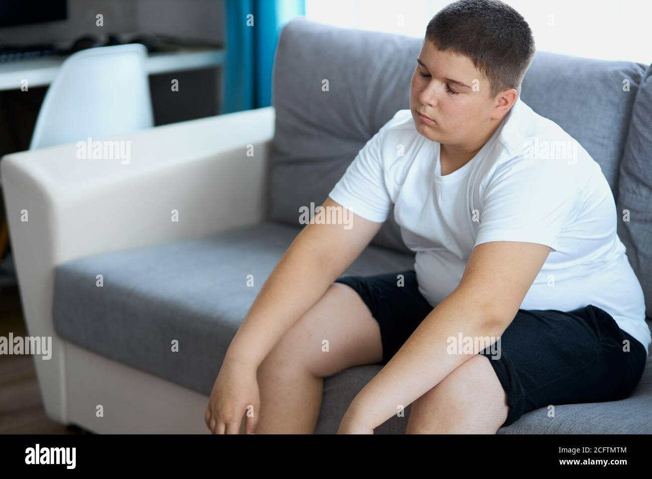 young overweight boy want to sleep, sit with closed eyes. sleepy ...
