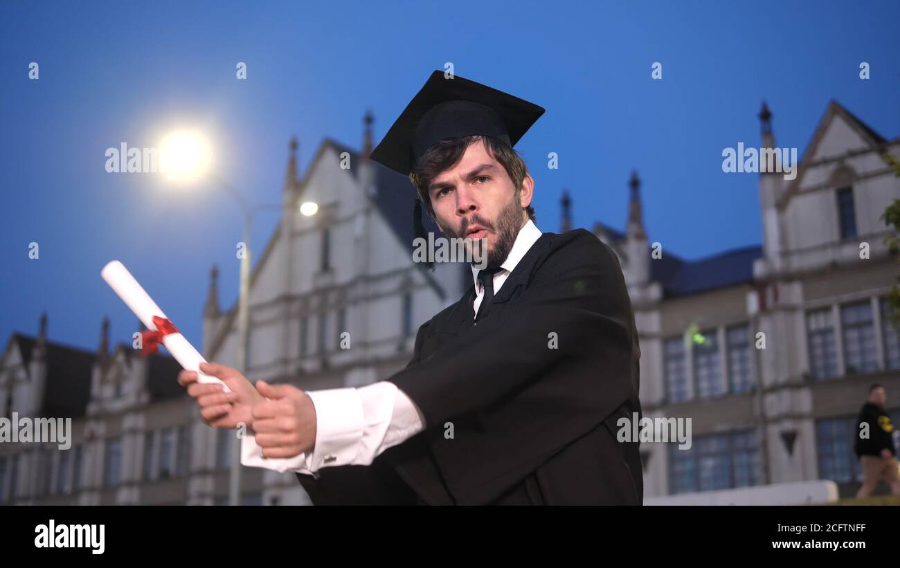 Happy student celebrating graduation dancing hi-res stock photography ...