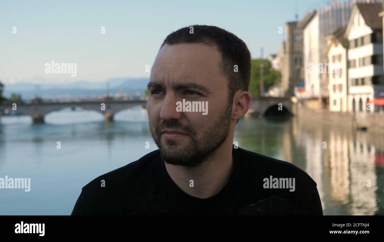 Angry young man, about to have nervous breakdown looking around in the ...