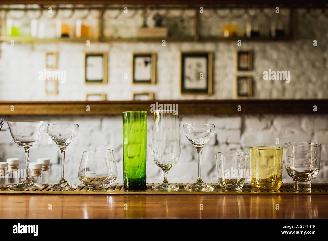 Different kinds of glasses on a bar counter, rocks, old fashioned ...