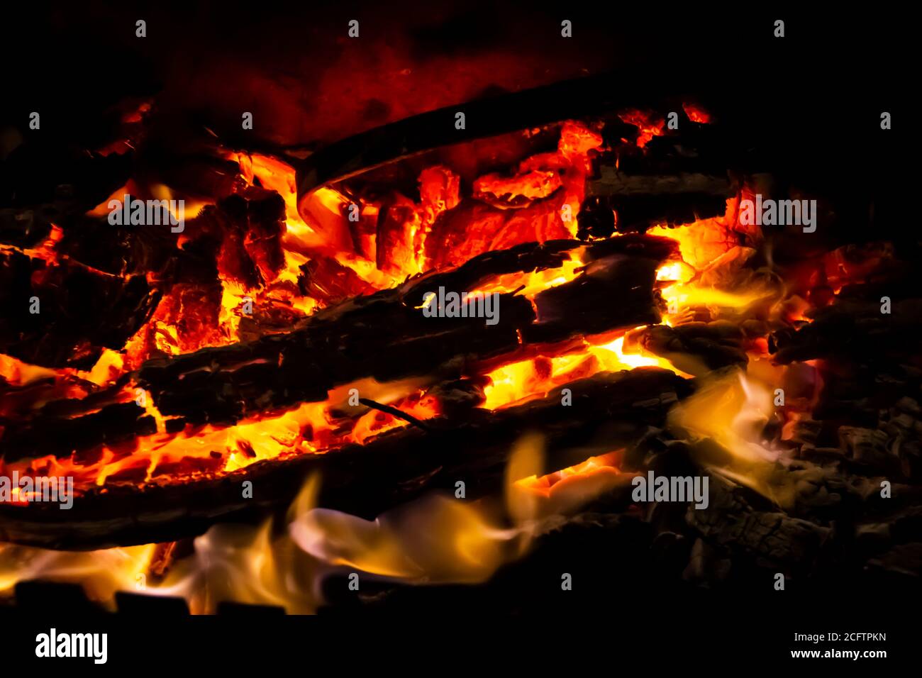 Red coals with fire on black background. Burning coals and wood in fire ...