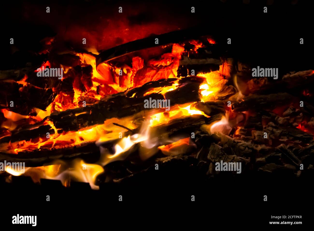 Red coals with fire on black background. Burning coals and wood in fire ...