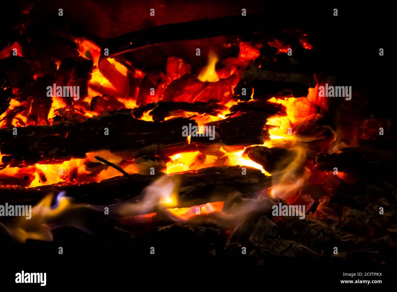 Red coals with fire on black background. Burning coals and wood in fire ...