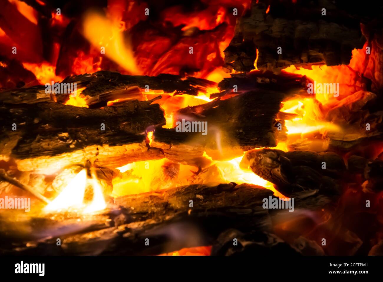 Red coals with fire on black background. Burning coals and wood in fire ...