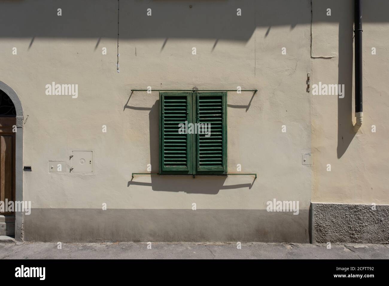 Italian Window with Wooden Shutters in a brick wall Stock Photo - Alamy