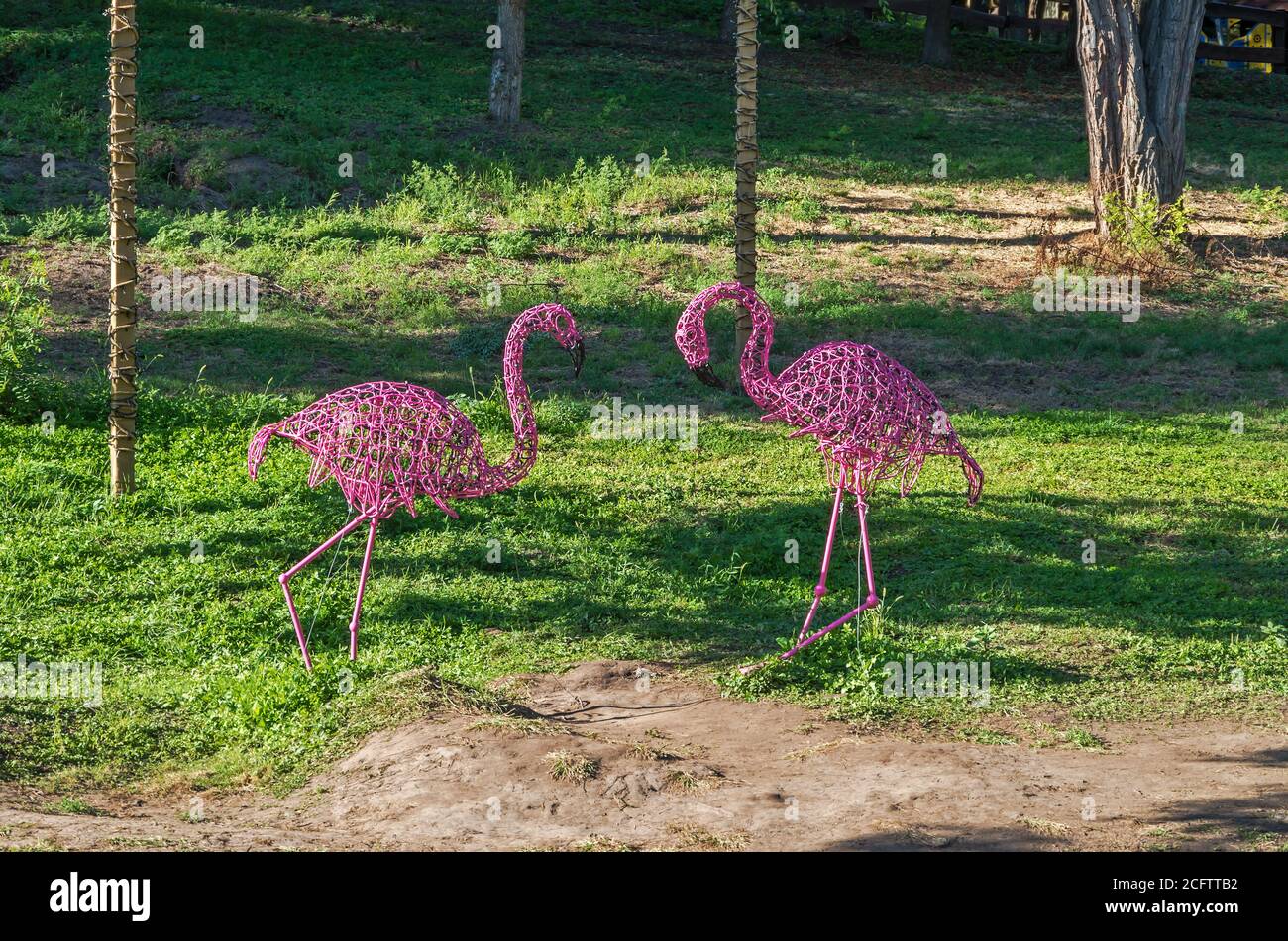 Homemade flamingo sculptures installed in clearing under the trees as ...