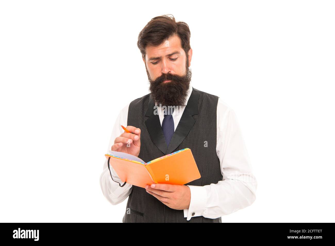 Concentrated bearded man write in school exercise book doing homework ...