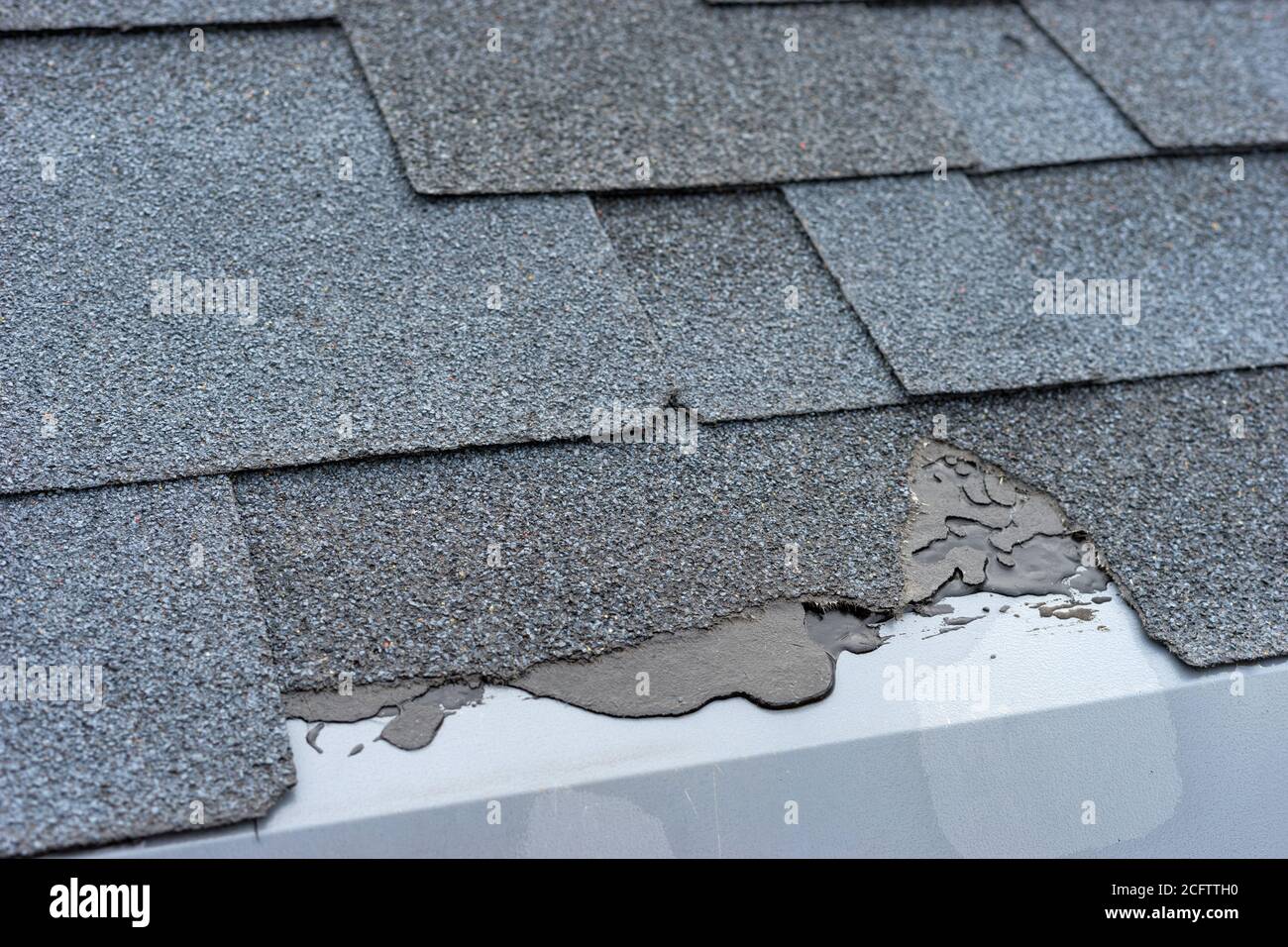 Сloseup view of asphalt shingles roof damage that needs repair Stock ...