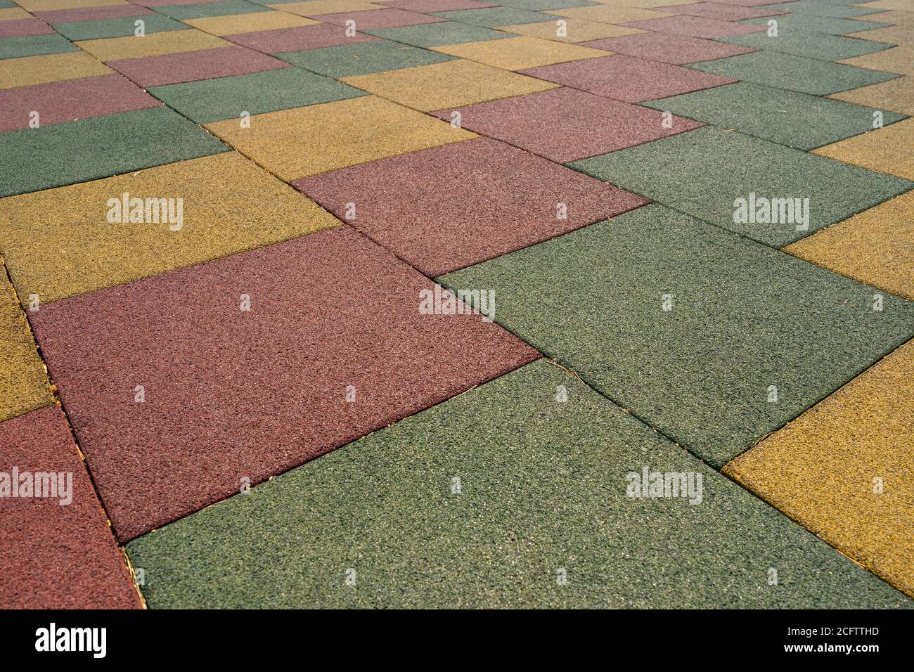 Colored rubber square paving slab for playgrounds close-up Stock Photo ...