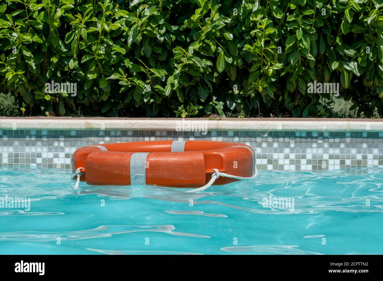 Swimming pool and a lifebuoy Stock Photo - Alamy