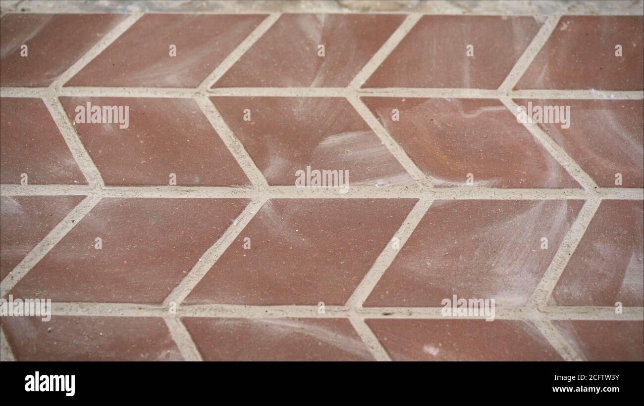 a worker laying red concrete paving blocks. Lay paving stones Stock ...