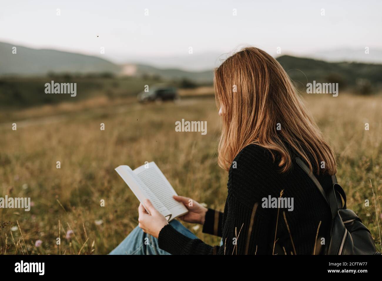 Young girl reading a book in the nature Stock Photo - Alamy