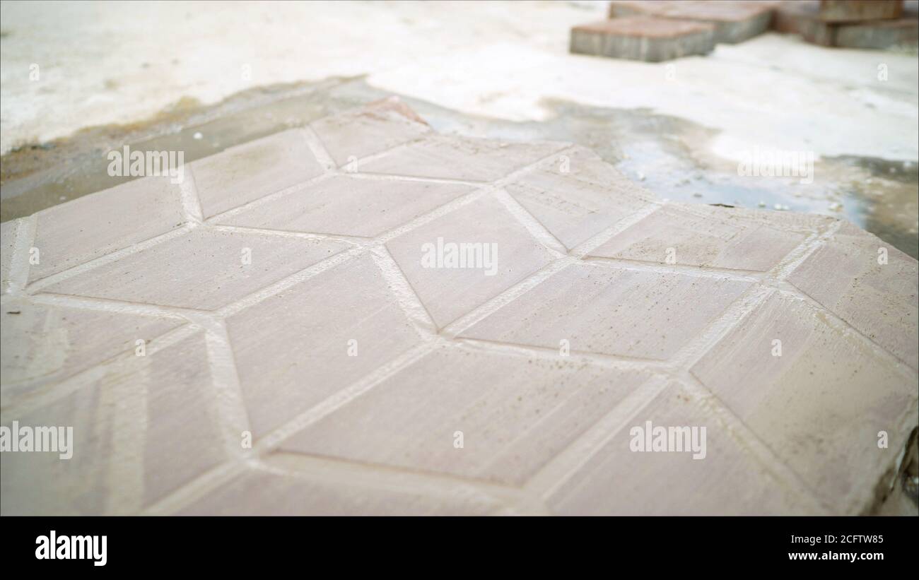 a worker laying red concrete paving blocks. Lay paving stones Stock ...