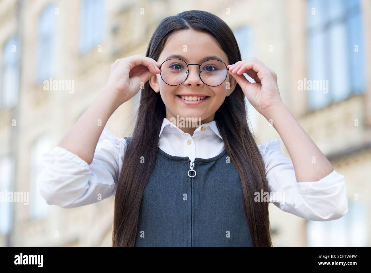 Looking to future. Happy kid fix eyeglasses outdoors. Eye sight ...