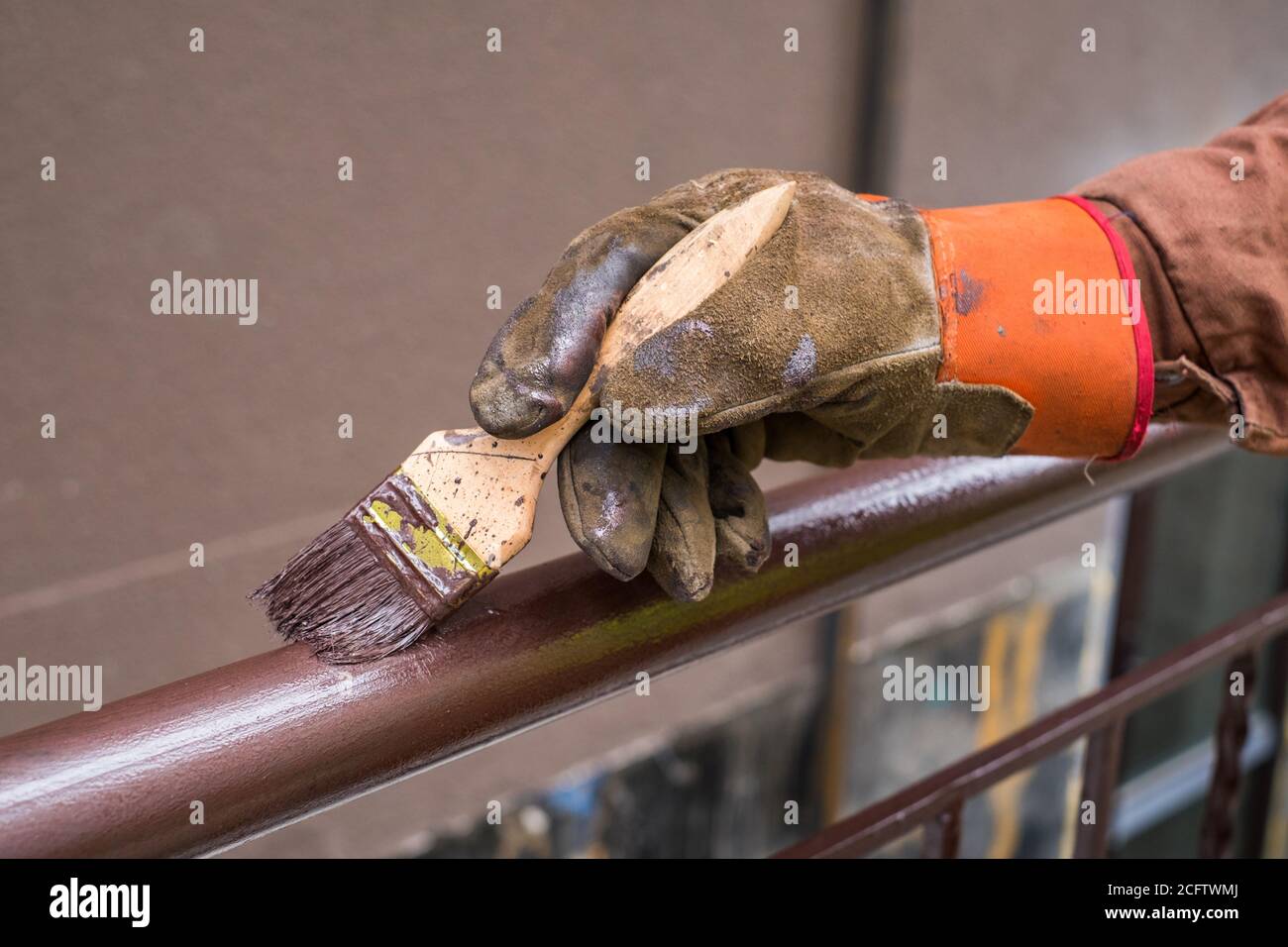 Contractor's hand with brush that painting metal railing construction ...