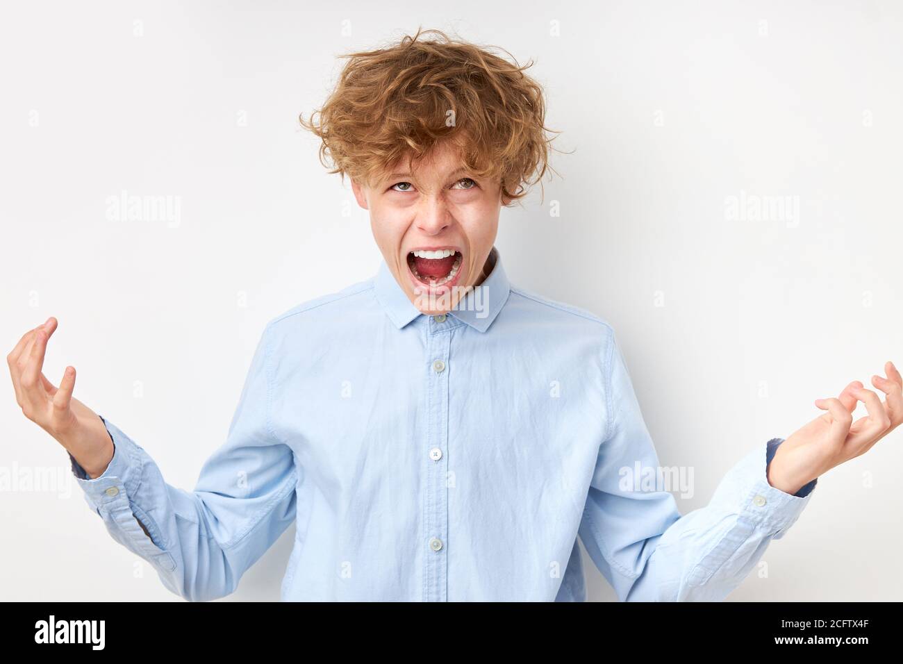 everything pisses him off, overwhelmed boy screaming at camera isolated ...