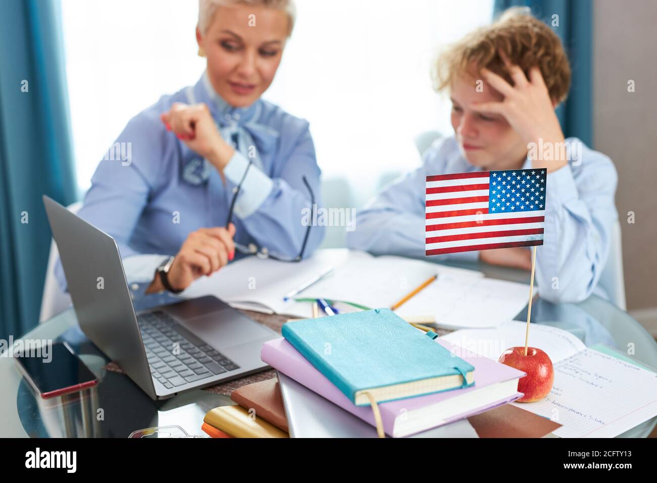 english tutor is engaged with the child, teaches languages at home ...