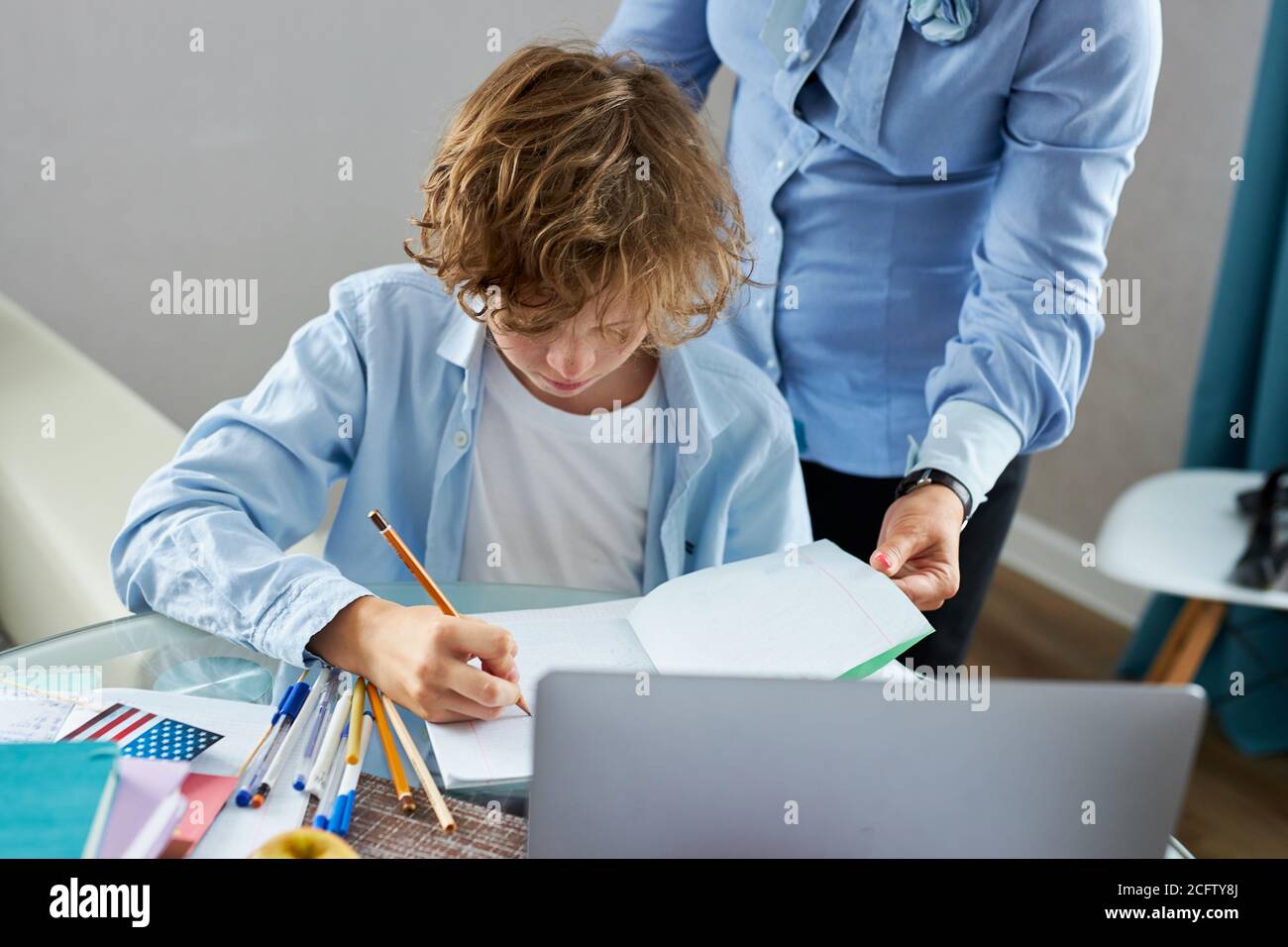 math teacher teach young teen boy at home, explain math tasks and ...