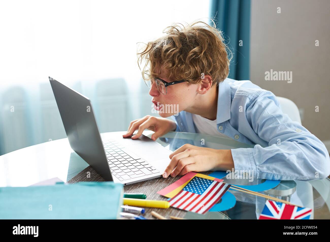 wonk schoolboy look at screen of laptop, do homework. he is poorly ...
