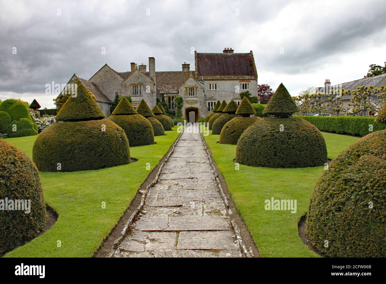An old flag stone path leads up to an English country house. The path ...