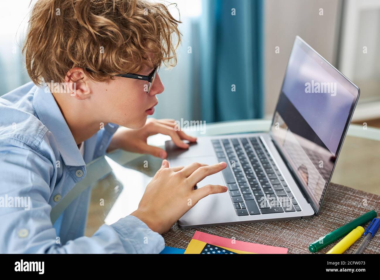 wonk schoolboy look at screen of laptop, do homework. he is poorly ...