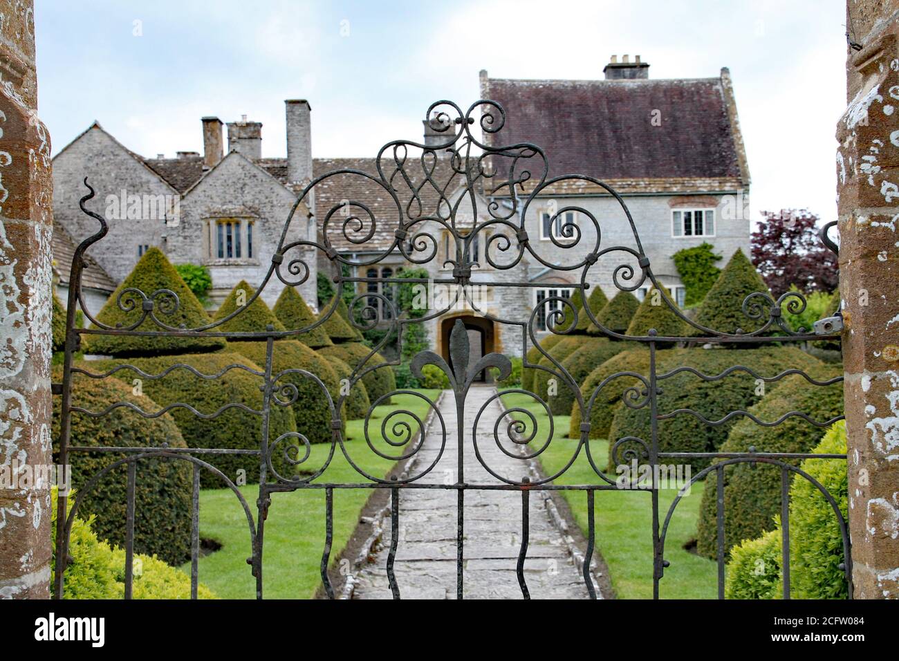 An old flag stone path leads up to an English country house viewed ...