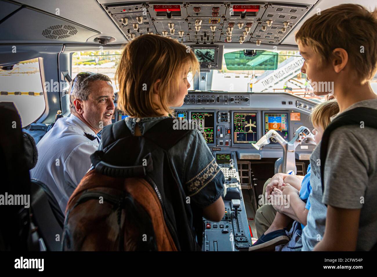 Children talk shop with pilot in cockpit. Nice if there can be a tour ...