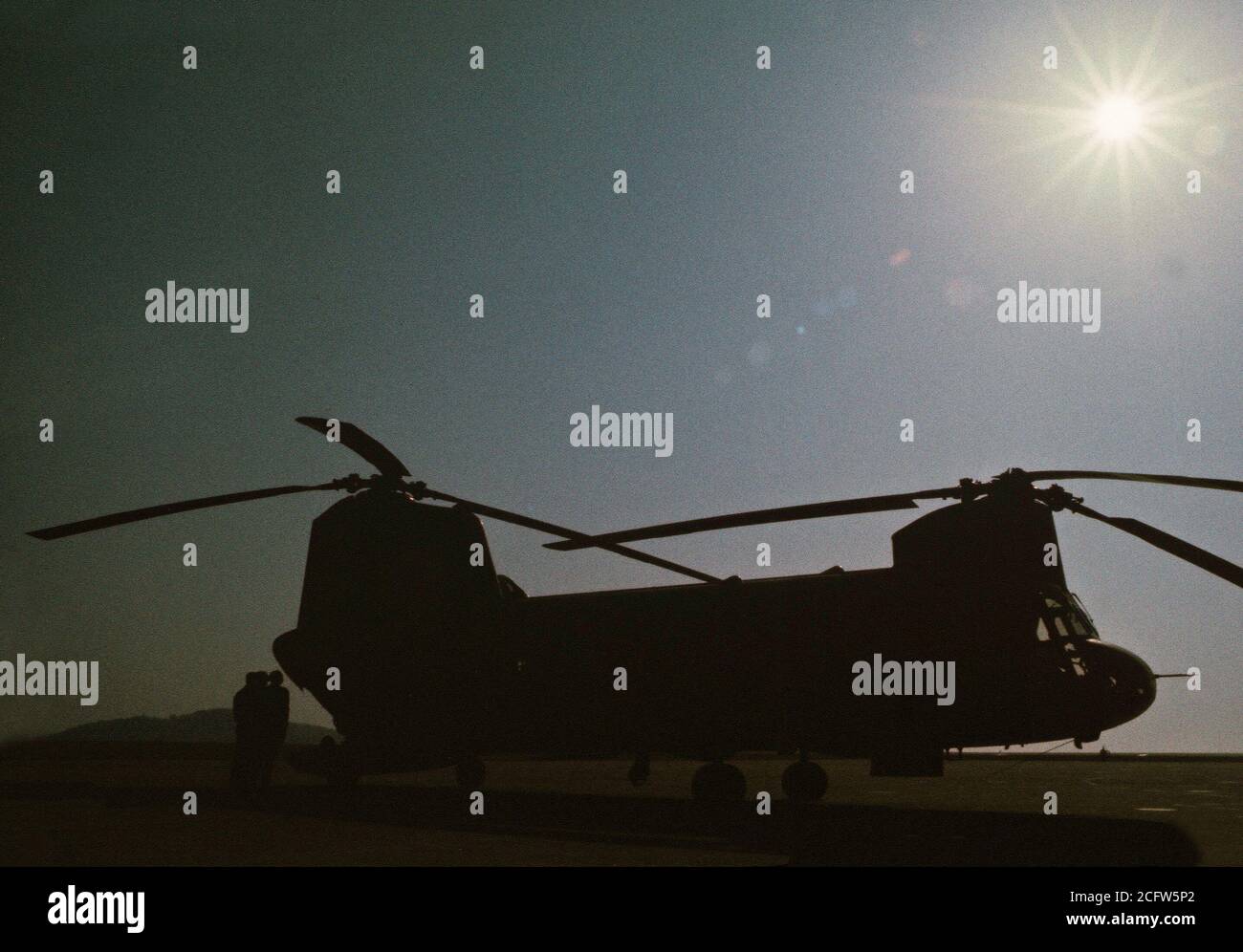 1979 - A US Army CH-47 Chinook helicopter is silhouetted against the ...