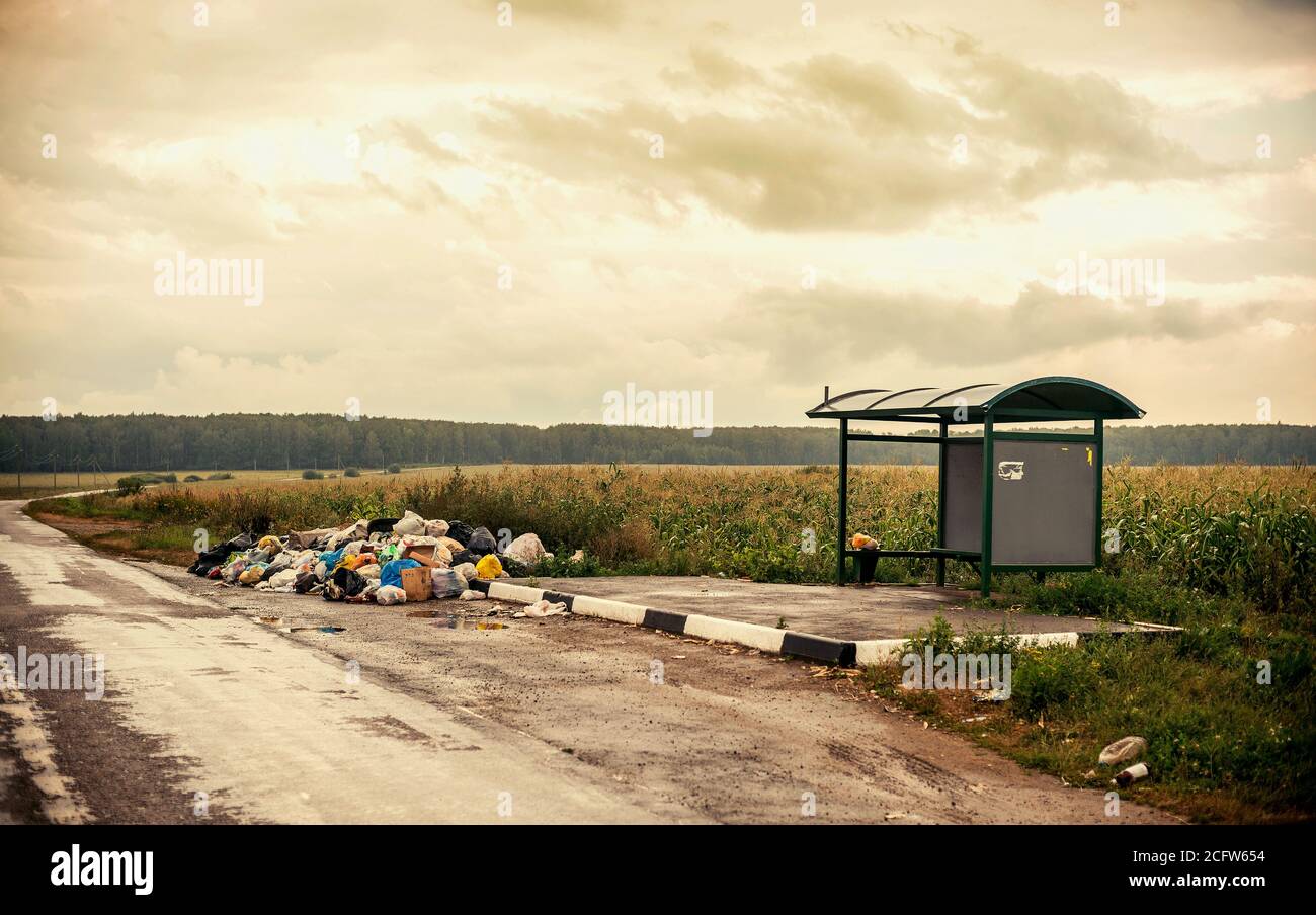 trash dump on bus stop Stock Photo - Alamy