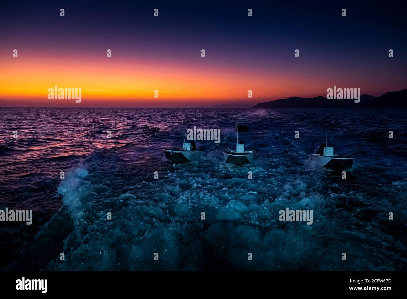 Tender boats of the True North at late dusk, Sunda Islands, Indonesia ...