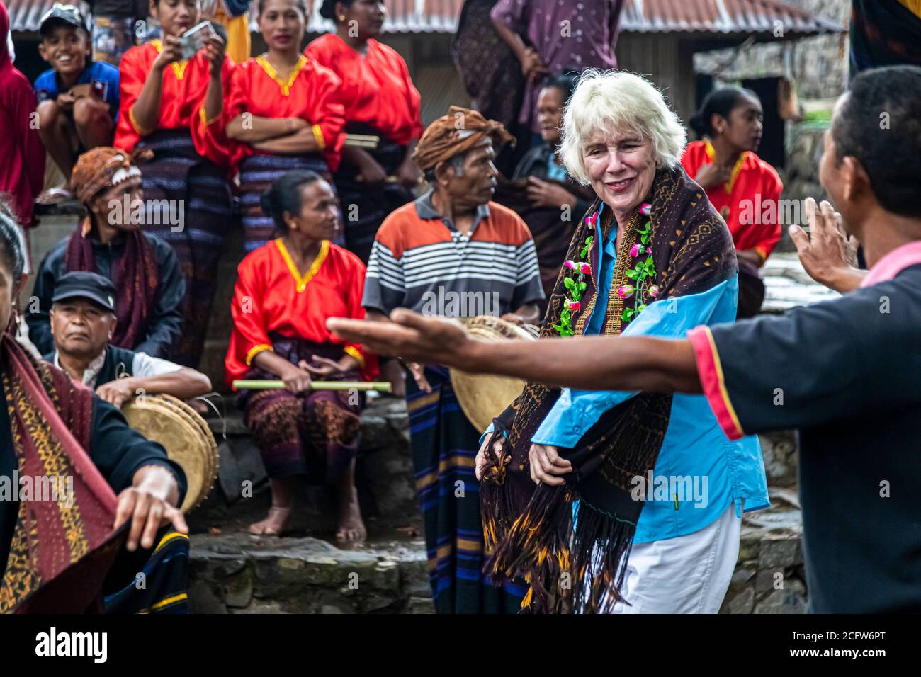 Indonesian People in traditional attire meeting with tourists Stock ...