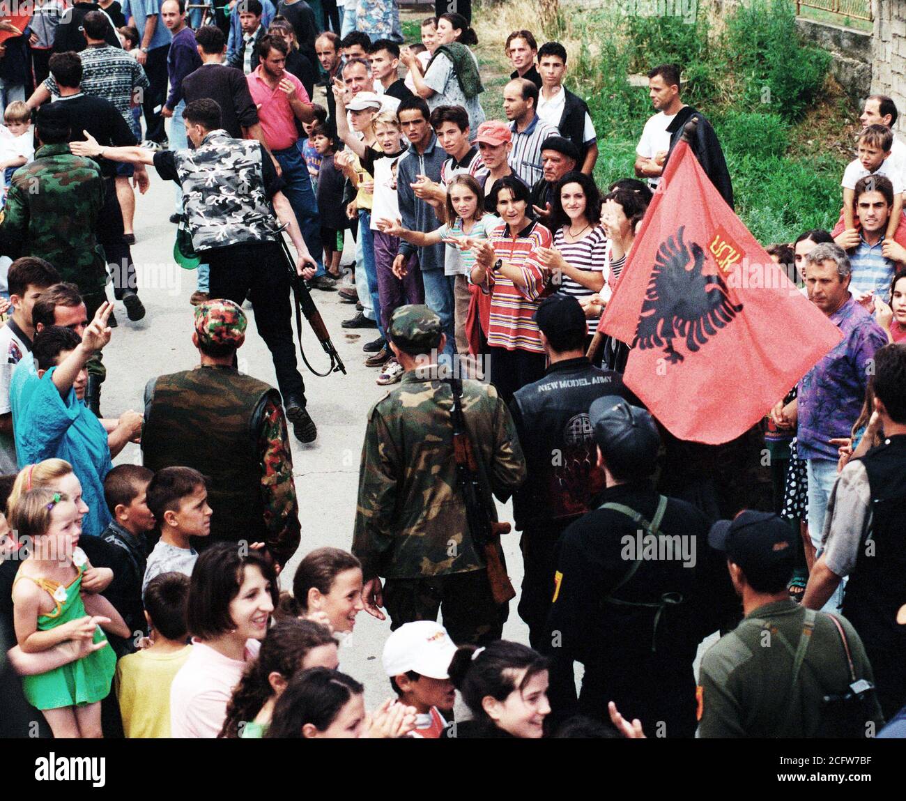 Members of the local KLA, Kosovo Liberation Army, march through the ...