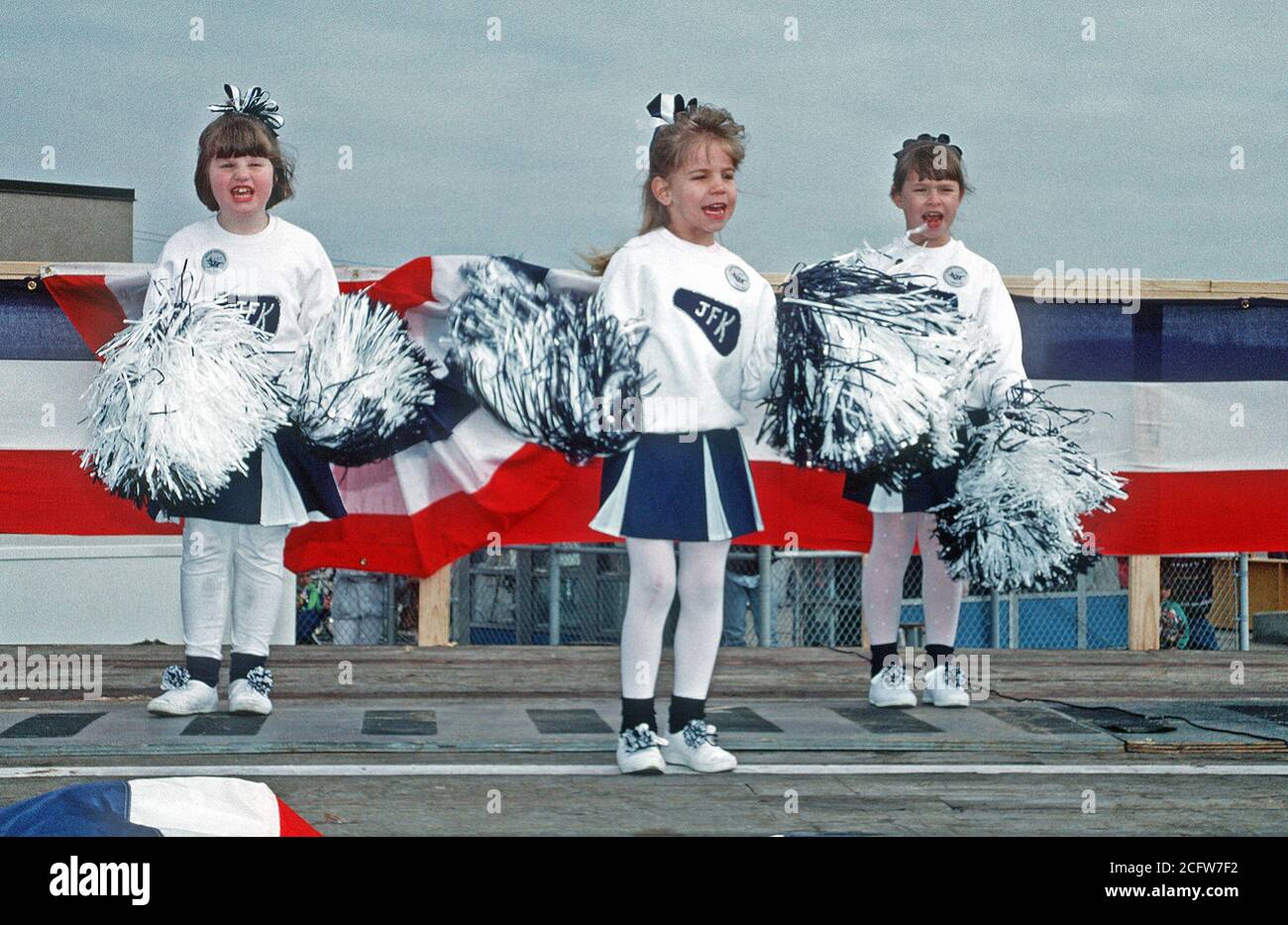 The JFK cheerleaders perform while waiting for their namesake, the ...