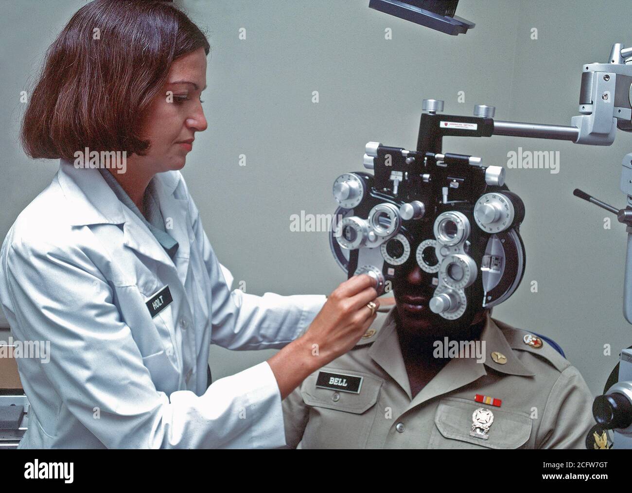 1978 - A female U.S. Army optometrist conducts a vision test Stock ...